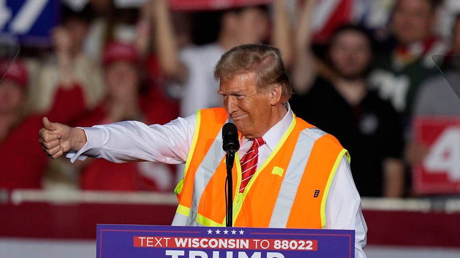 Donald Trump wears garbage worker vest to rally in critical swing state ...